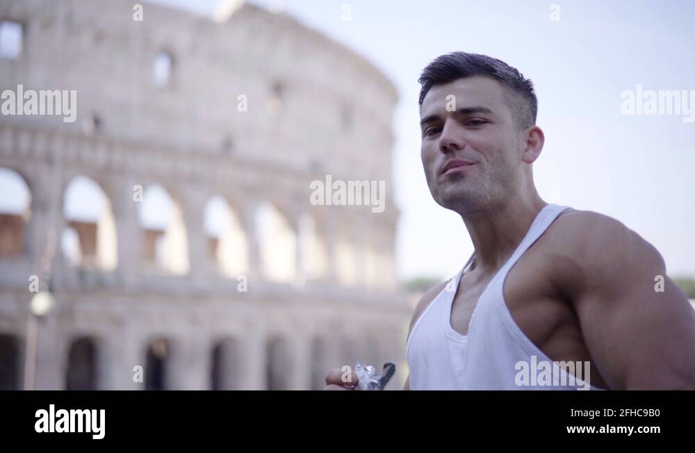 Bodybuilder eats after a training session. A man eats a energy ...