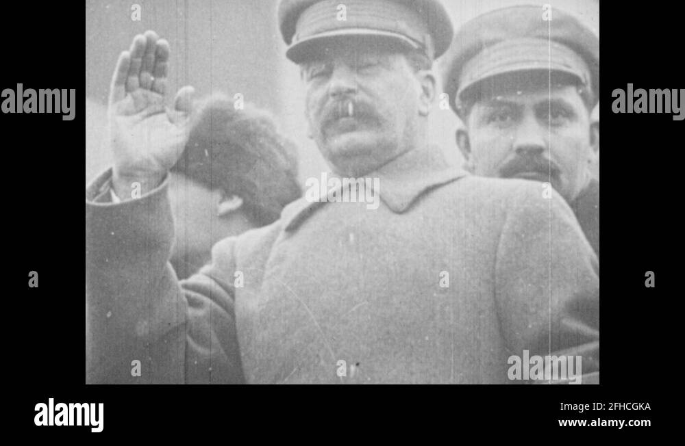 1930s: Stalin waves at crowd. People parade. Images of Stalin and Lenin ...