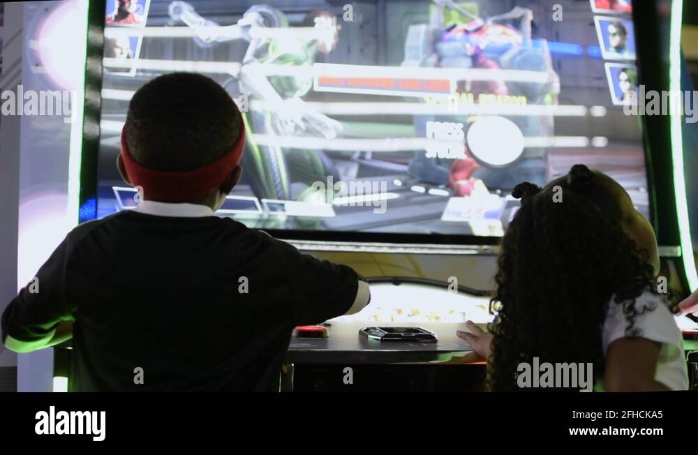 Kids playing against each other on a fighting arcade game Stock Video ...