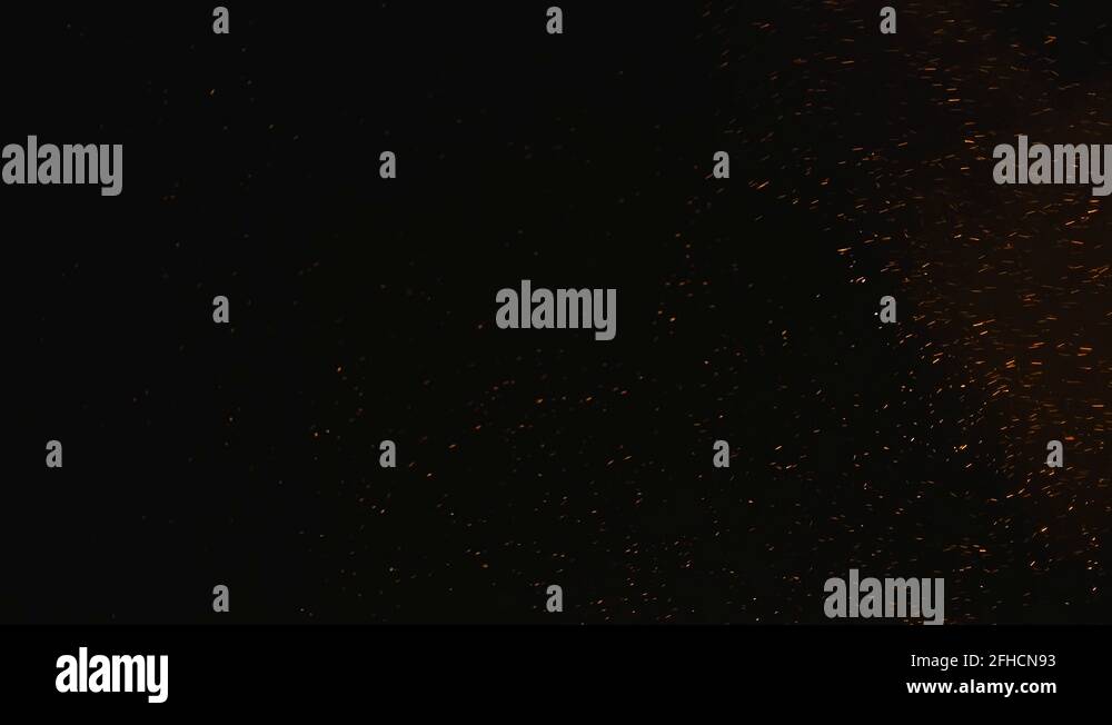 Big campfire with sparks/ particles/ ashes and stars in background ...