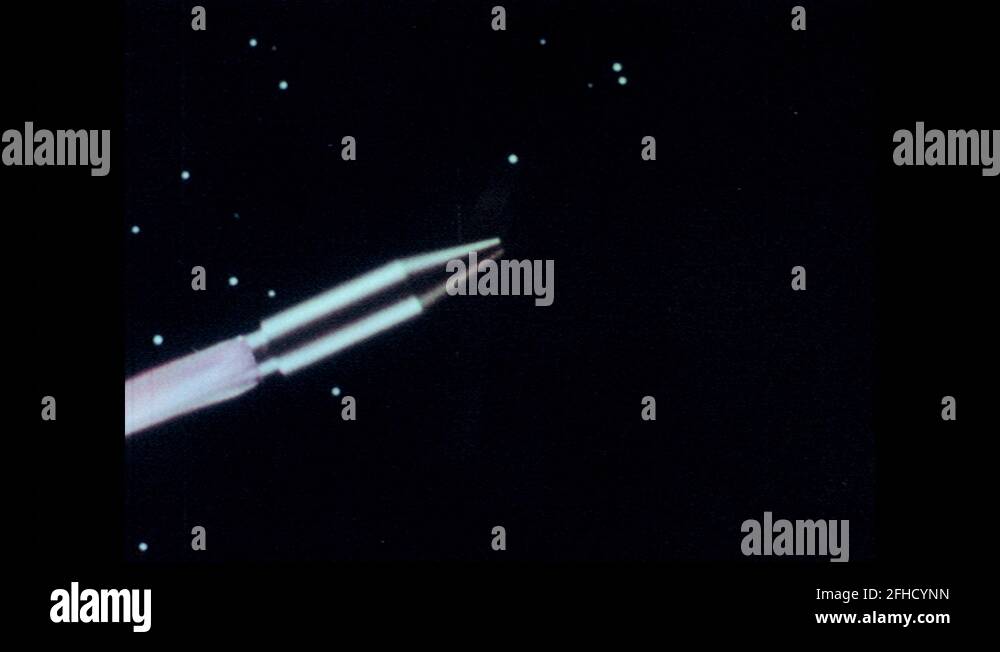 1960s: Fire plumes from back of rocket in space. Rocket engines cease ...