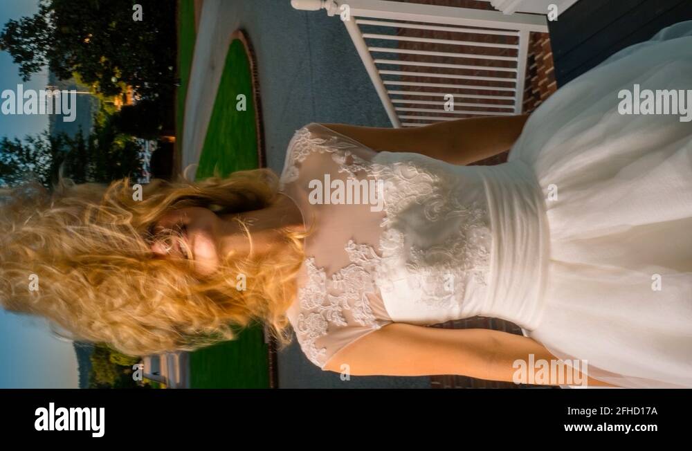 Vertical Video of girl throwing hair back in wedding dress Stock Video ...