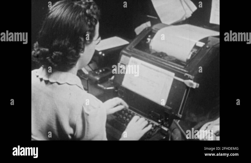 1950s: Woman types. Teletype machine. Men load meat into refrigerated ...