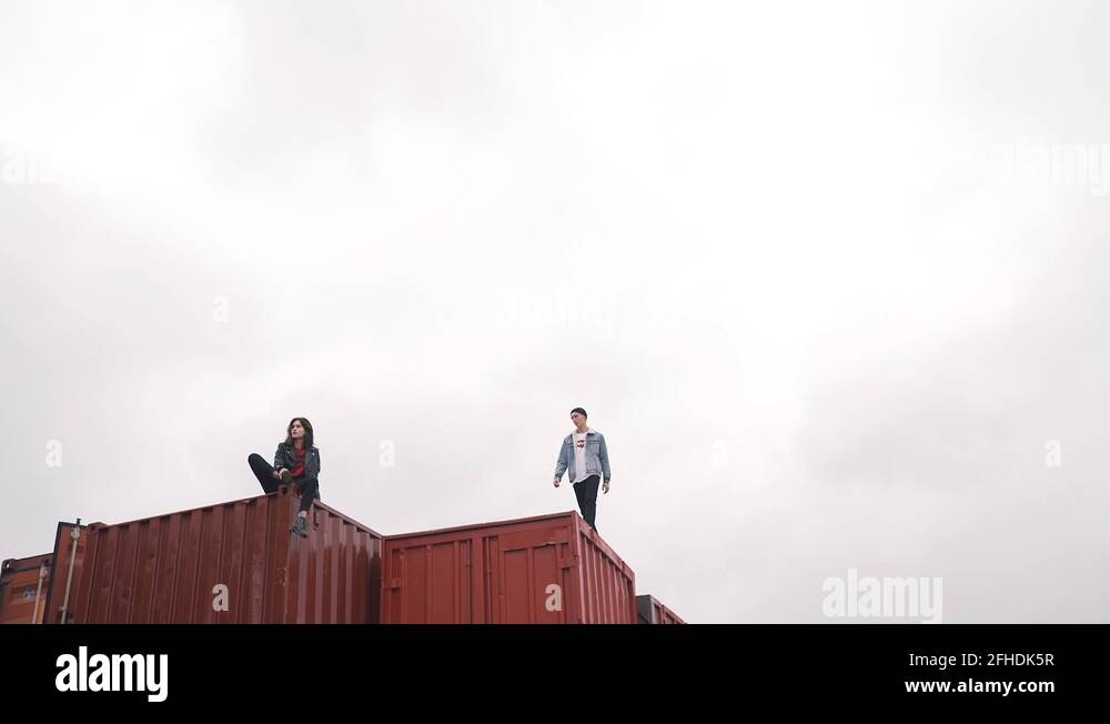 young couple in denim on a freight container Stock Video Footage - Alamy