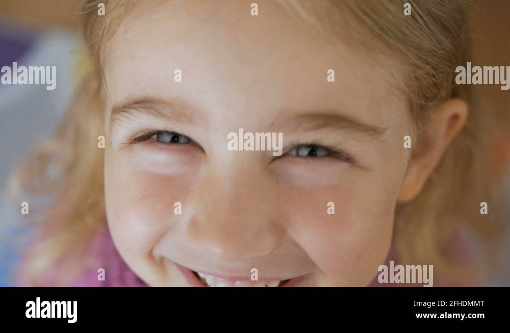 Close-up portrait of a happy little girl bursting in laugh Stock Video ...