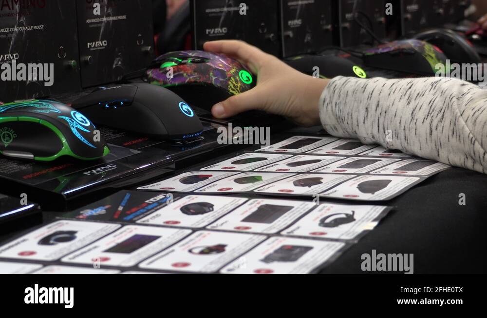 People trying colorful game mice on display at showroom Stock Video ...