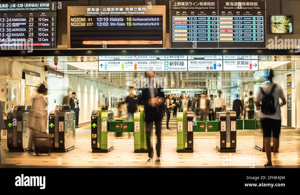 Entrance of metro railway station. People go through turnstiles. Japan ...