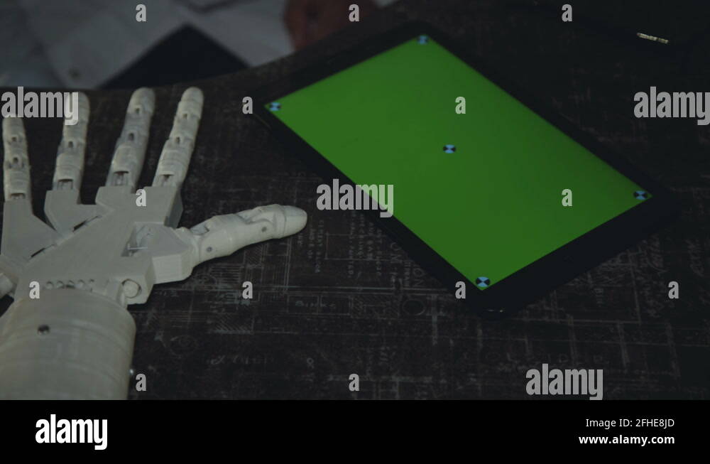 Scientist manage a prosthetic hand through android to perform clamp of ...