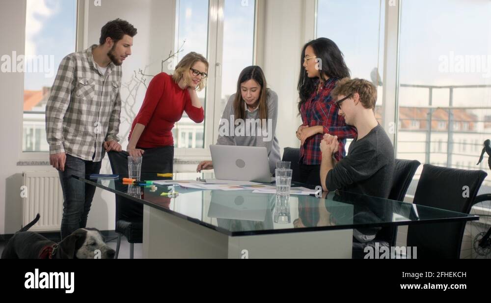Happy workers giving praise by clapping hands together for coworker ...