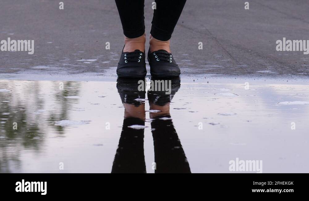 Woman legs jump in puddle, water splash in air, slow motion Stock Video ...