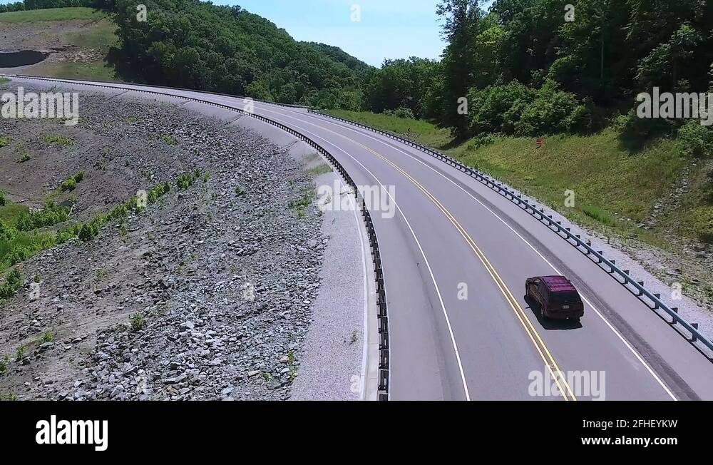 4K 30fps Arial footage of a car driving on a backroad Stock Video ...