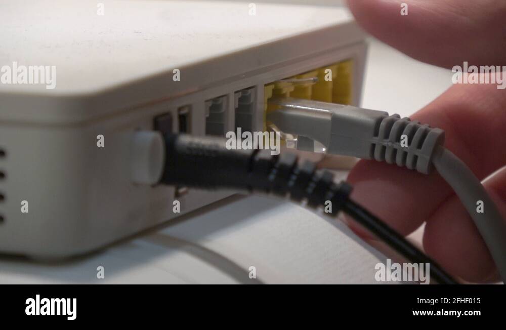 Hand plugs ethernet cable into router Stock Videos & Footage - HD and ...