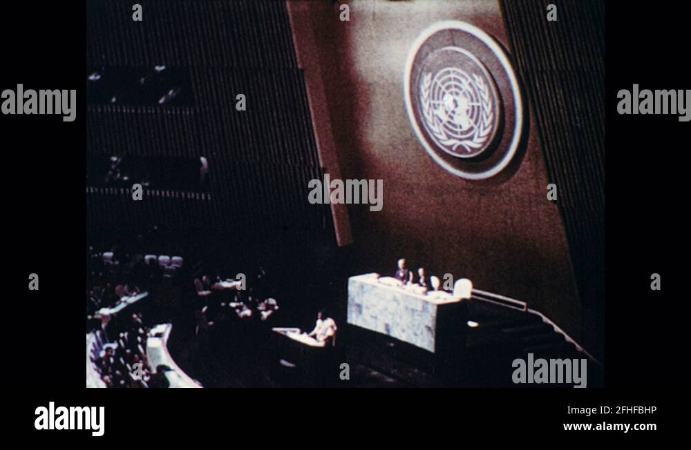 1960s: United Nations podium, curved row seats. Rows of audience with ...