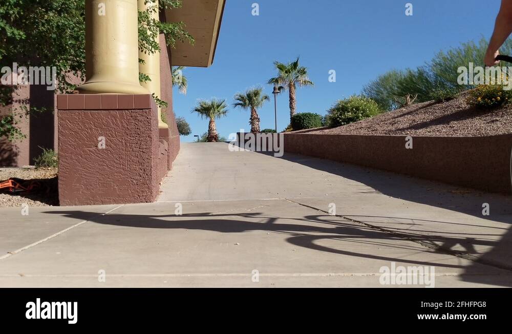 Man Riding Fixed Gear Bicycle Up Cement Ramp in Arizona with Slow Zoom ...