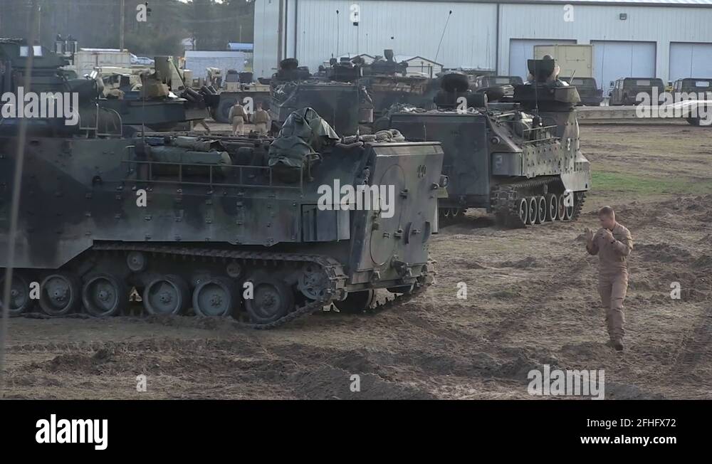 U.S. soldiers depart a Marine detachment motor pool on Fort Stewart ...
