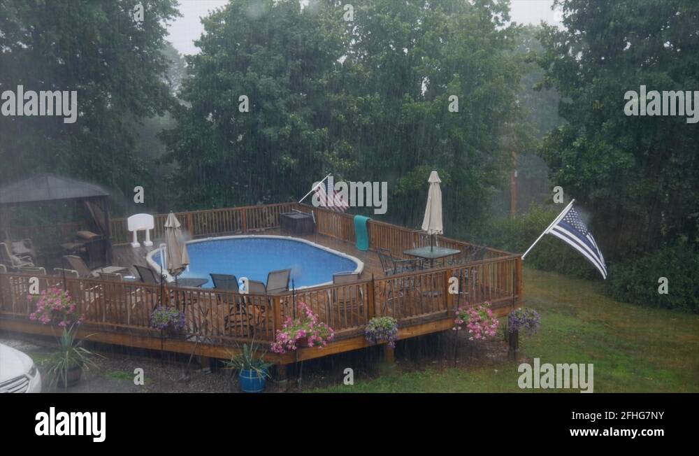 Watching a rainy day from inside through a window, watching rain douse ...