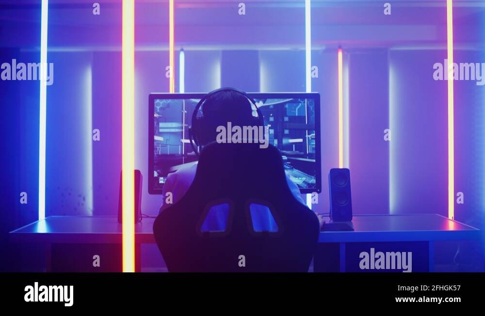 Back View of Pro Gamer Playing FPS Shooter on PC in Neon Room Stock ...