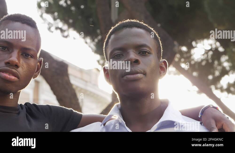 Friendship,brotherhood. Young black african men hugging and staring at ...