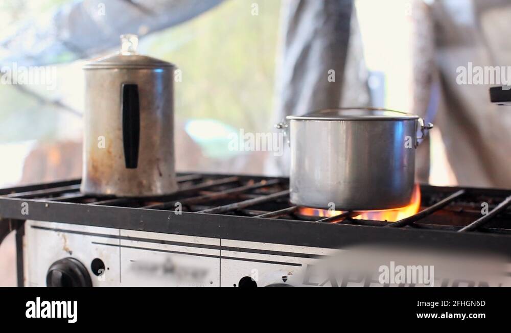 Pan Left to Right: Cooking in the Campsite Stock Video Footage - Alamy