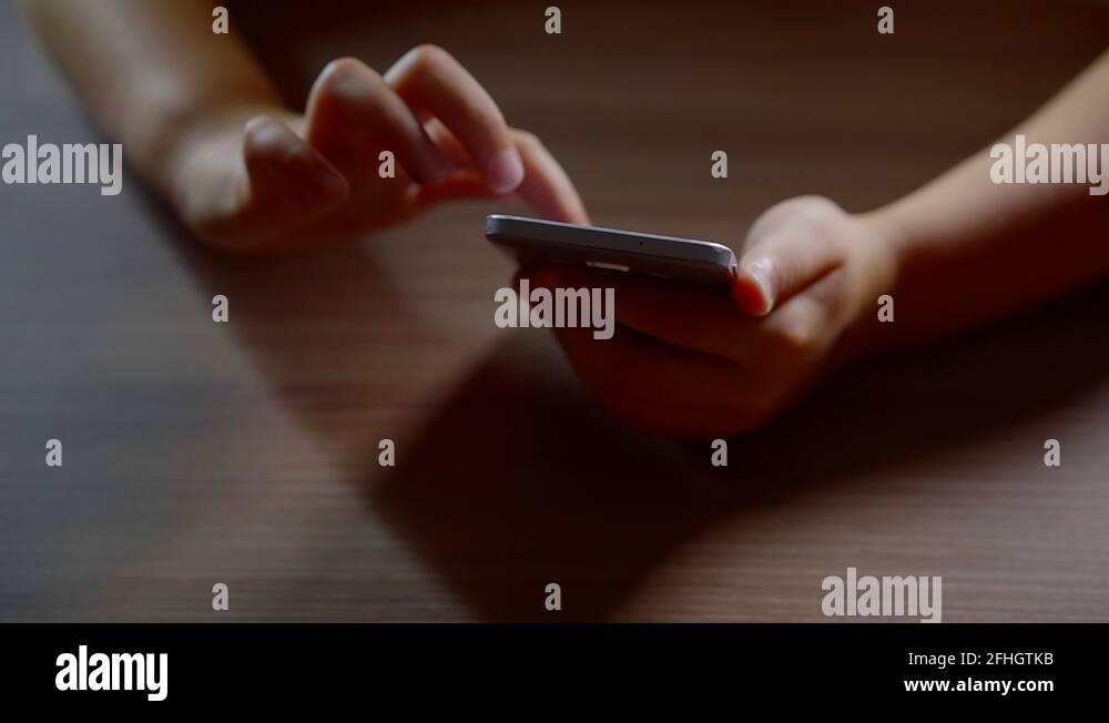 humans hands are touching screen of a modern smartphone, typing and ...