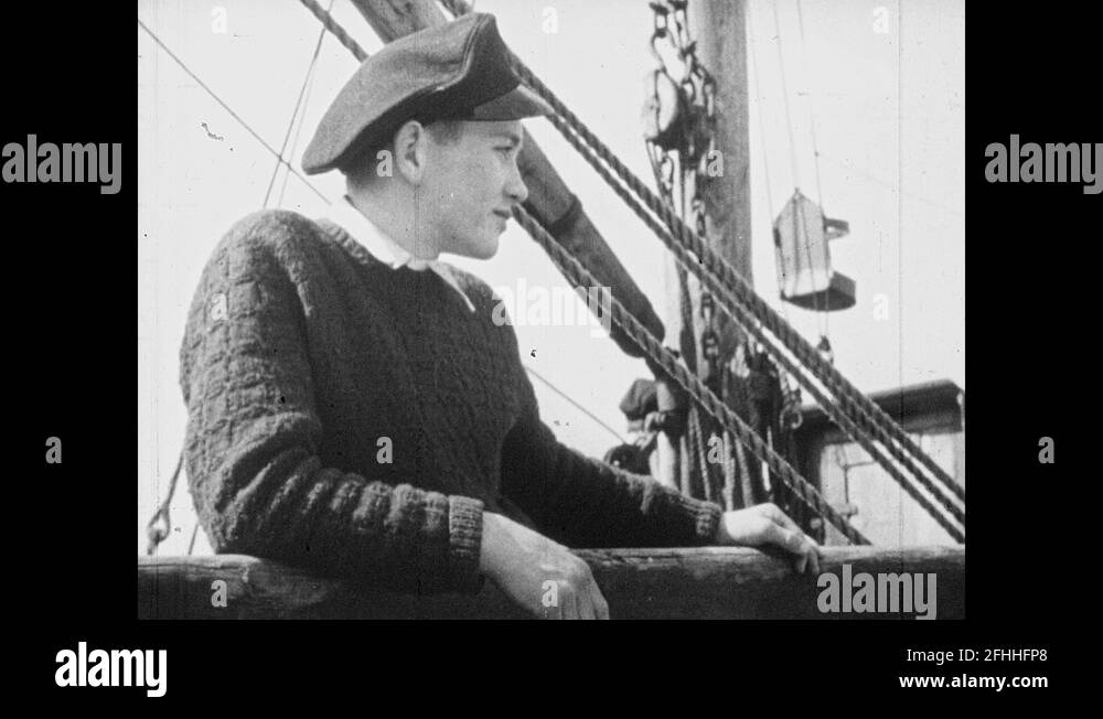 1950s: Ship. Boy stands at railing. Dock. Shadow. Boy ties and carries ...
