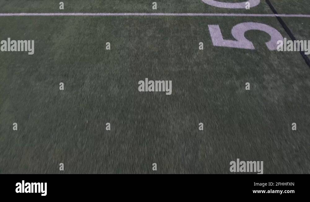 Flyover veiw of football field yardlines Stock Video Footage - Alamy