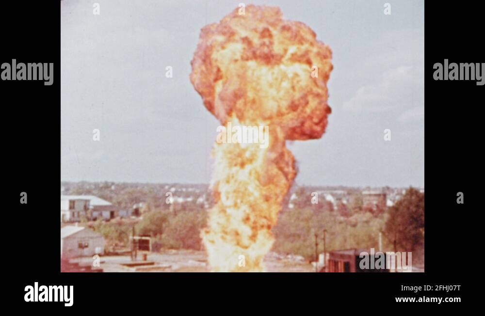 1950s: Column of fire rises from oil drums in field. Firefighters ...