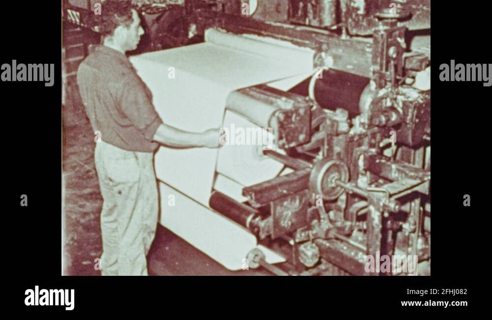 1950s: Man holds cloth on rolls at coating machine. Diagram of cloth ...