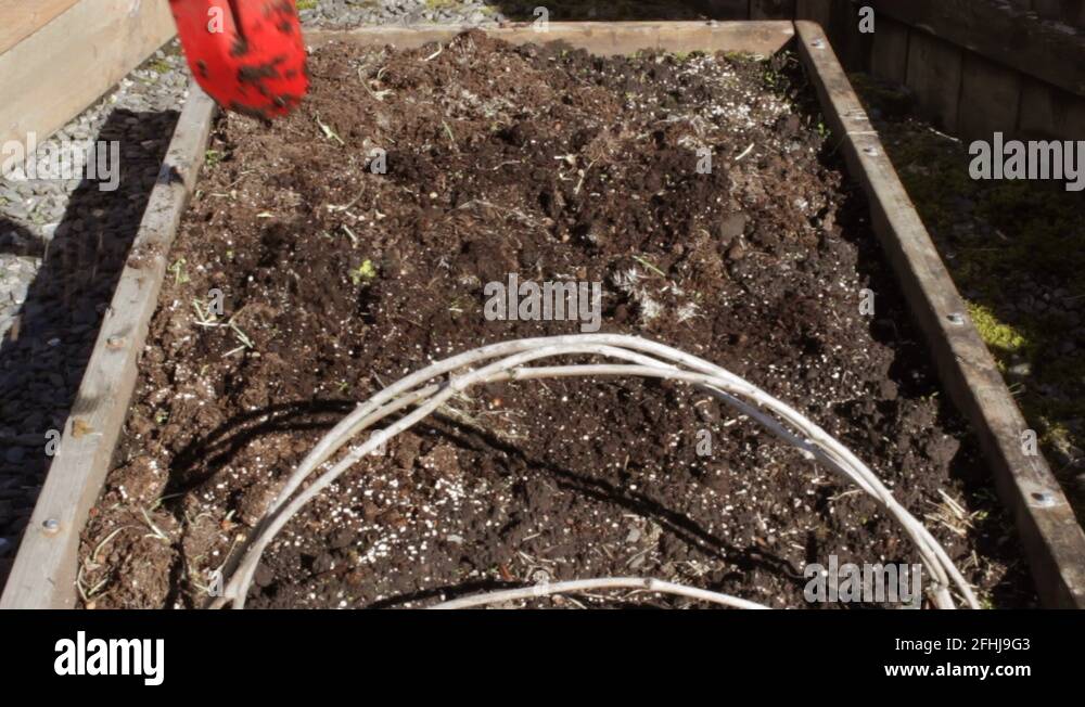 Preparing the garden in the spring. mixing old soil with new soil ...