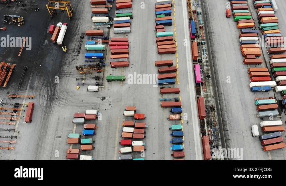 Shipping yard containers. aerial tilt reveal Stock Video Footage - Alamy