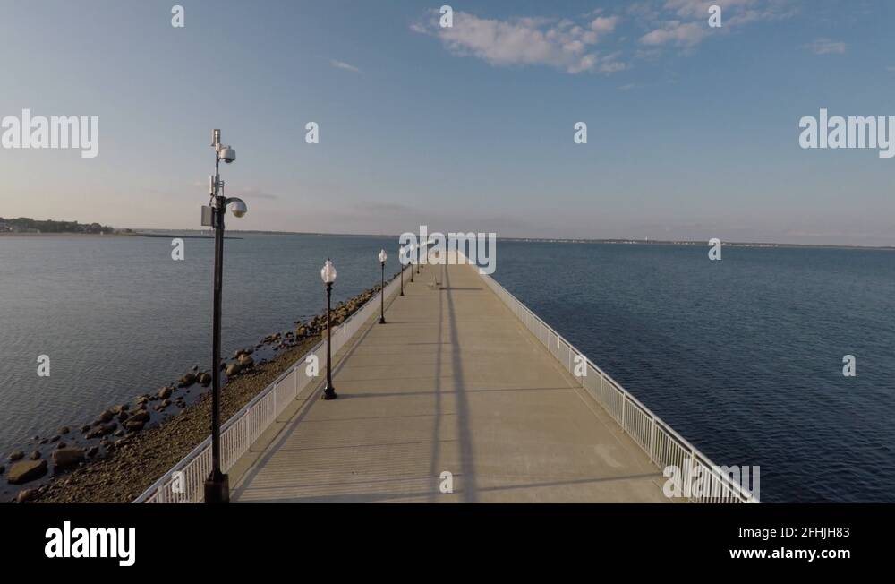 Drone flying backward from the oceans pier, revealing beautiful scenery ...