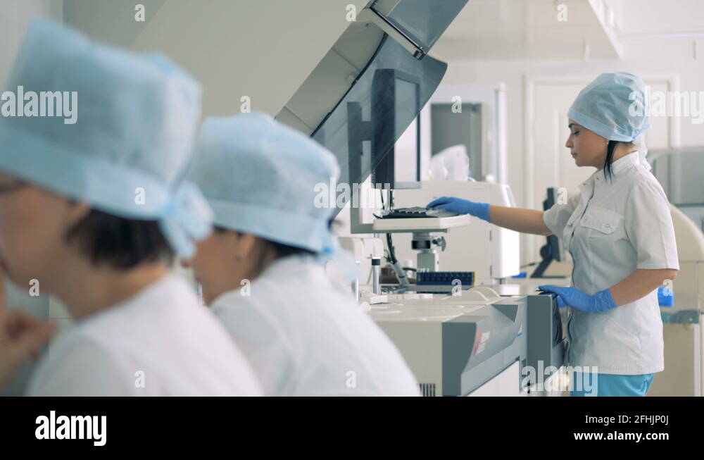 Female doctor is controlling functioning of a clinical chemistry ...
