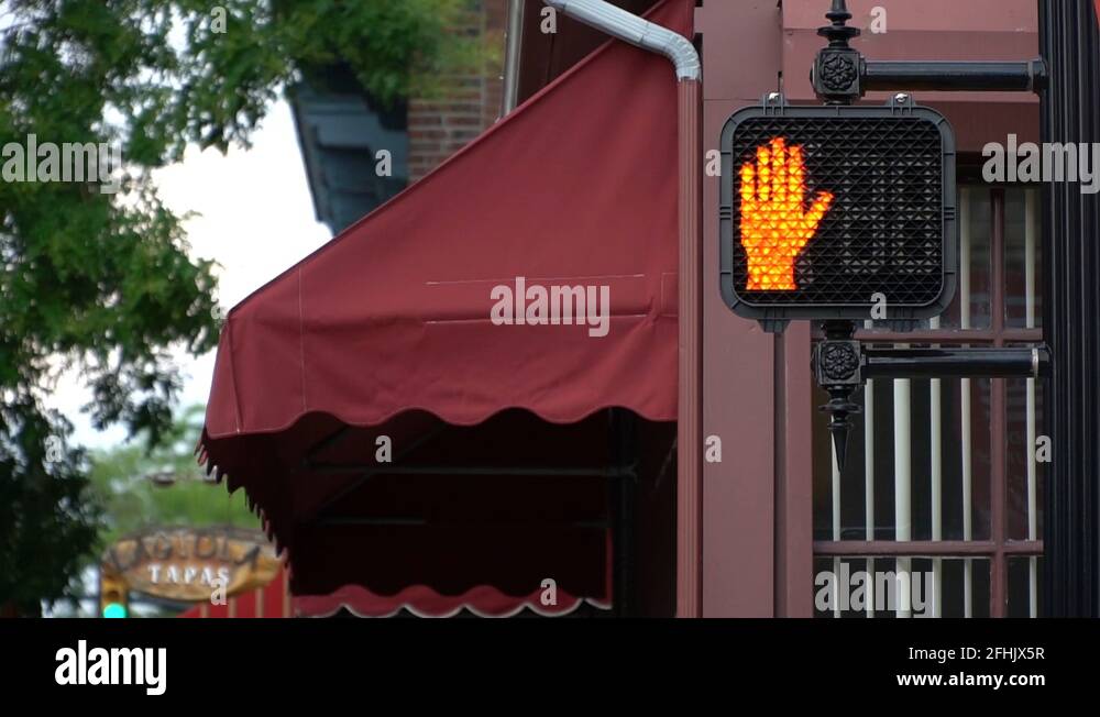 Stop sign of red hand sign at an intersection Stock Video Footage - Alamy