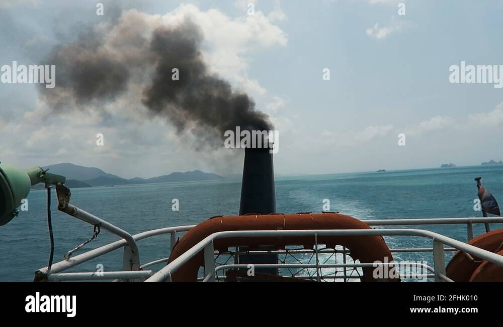 Footage of smoke rising form smoke stacks on a large ship in Thailand ...