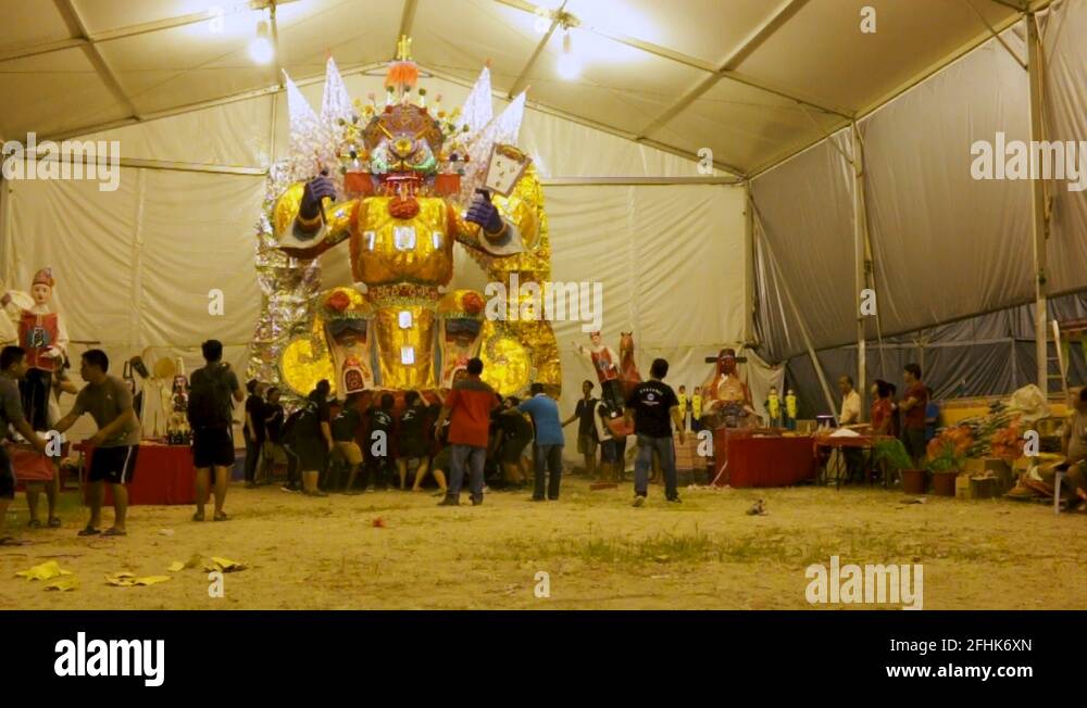 People areing paper-made statue of Chinese deity during Hungry Ghost ...