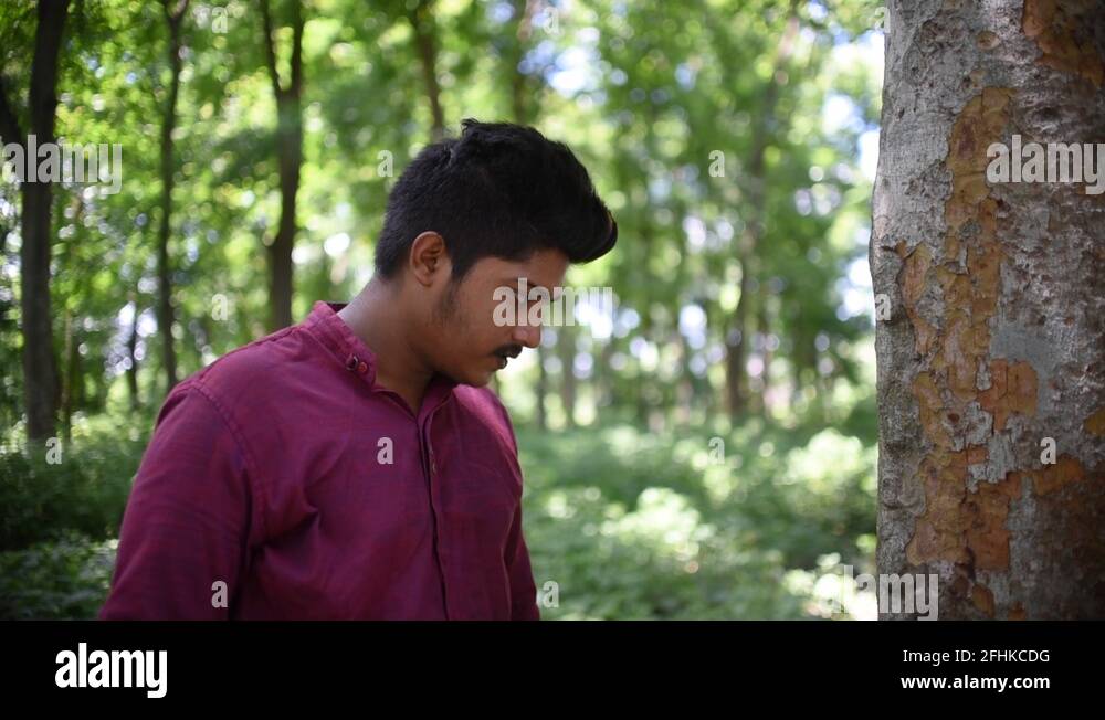 An angry and upset South Asian Indian man or boy is hitting and ...
