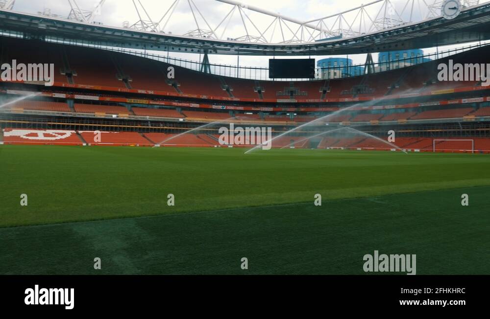 Interior view of Emirates Stadium as sprinklers water the soccer pitch ...