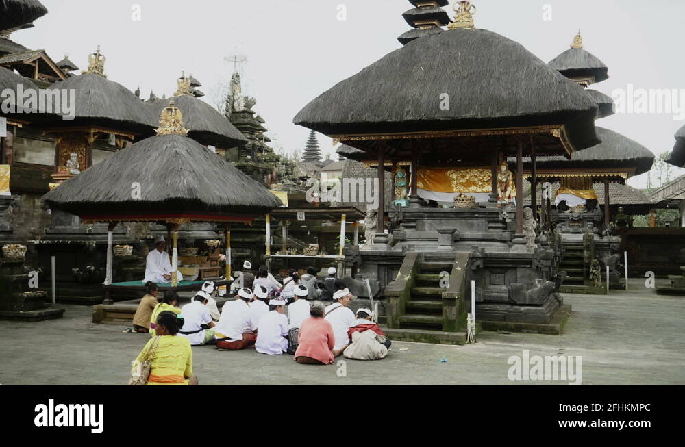 Balinese funeral ceremony with group of people in Pura Besakih temple ...