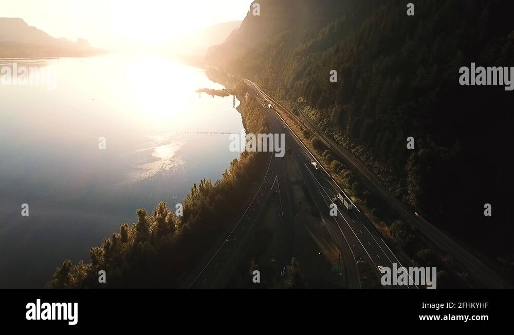 Cinematic drone shot taken as the sun rises over the hills of the ...