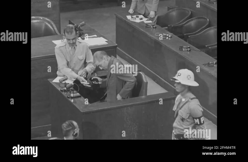 Defense witness Jiro Ichida listens court trail during war crimes ...