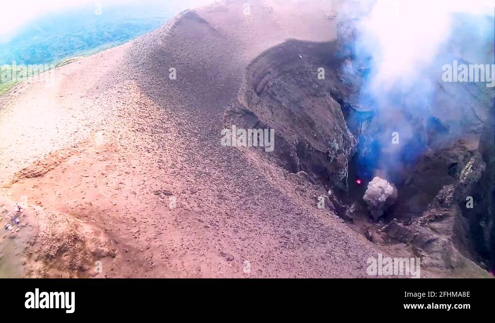 Volcano Mt Yasur Vanuatu erupting. Dramatic drone shots across top of ...