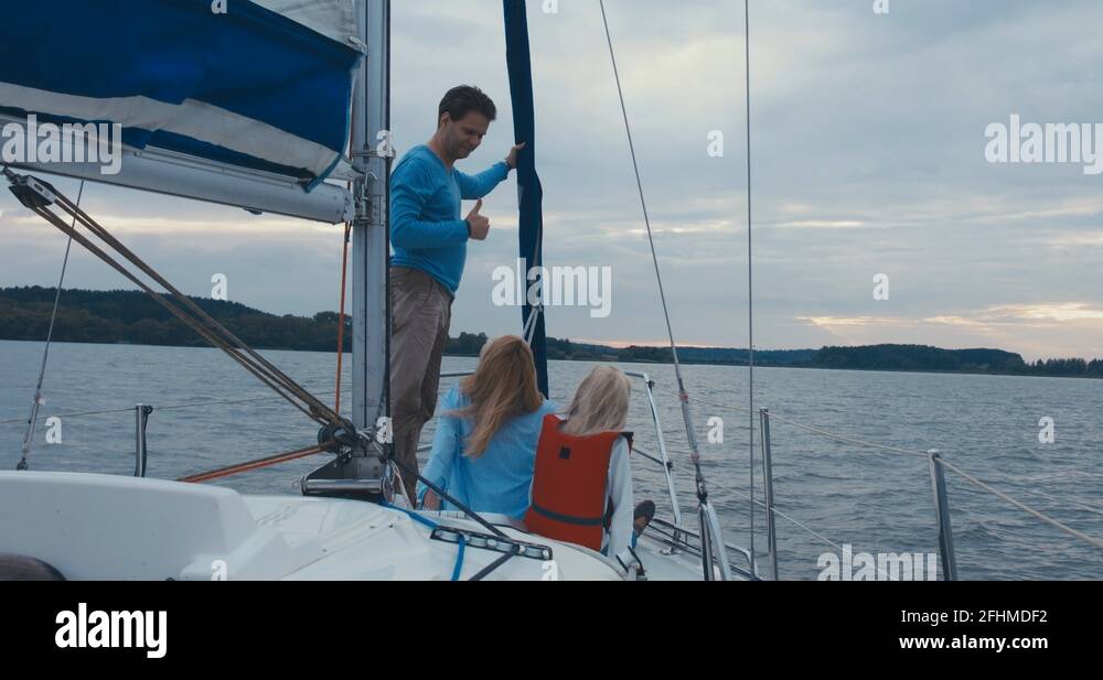 Caucasian family parents and two kids boy and girl enjoying their boat ...