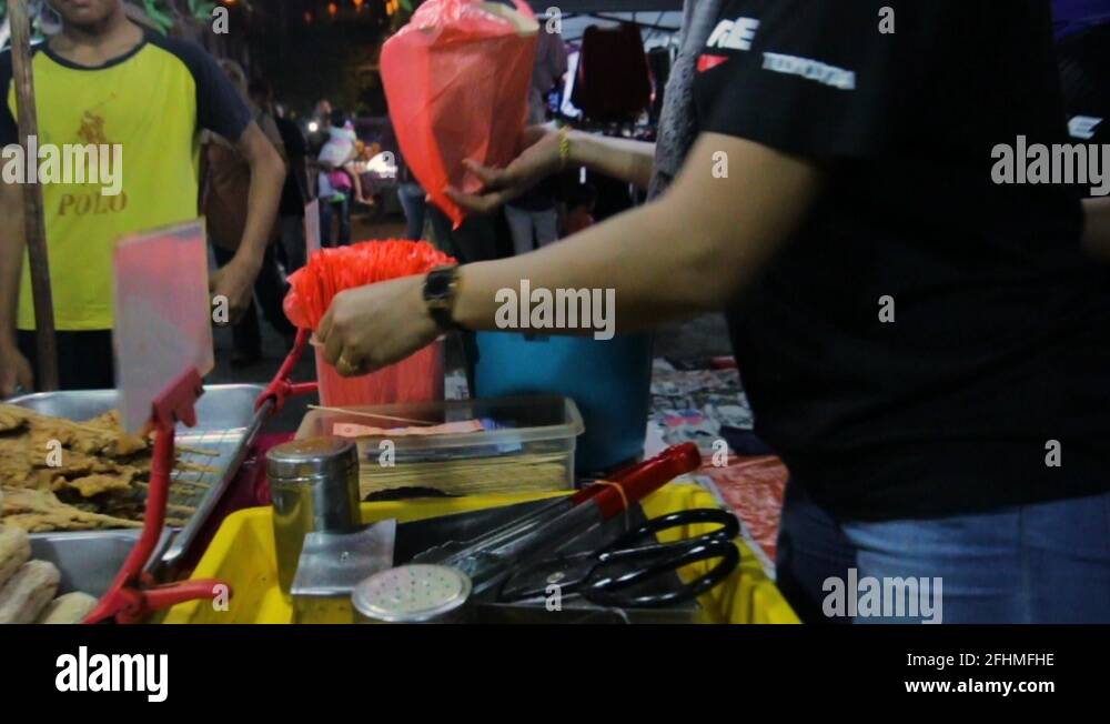 Delicious street food being sold to shoppers at a typical Asian market ...