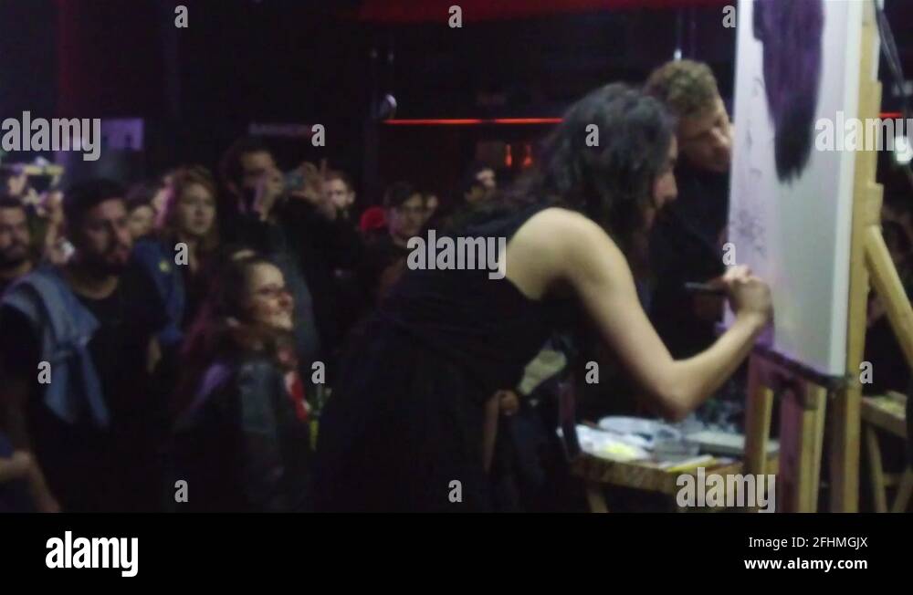 Artist Painting In Front Of Crowd In Dark Art Gallery - Static Stock ...