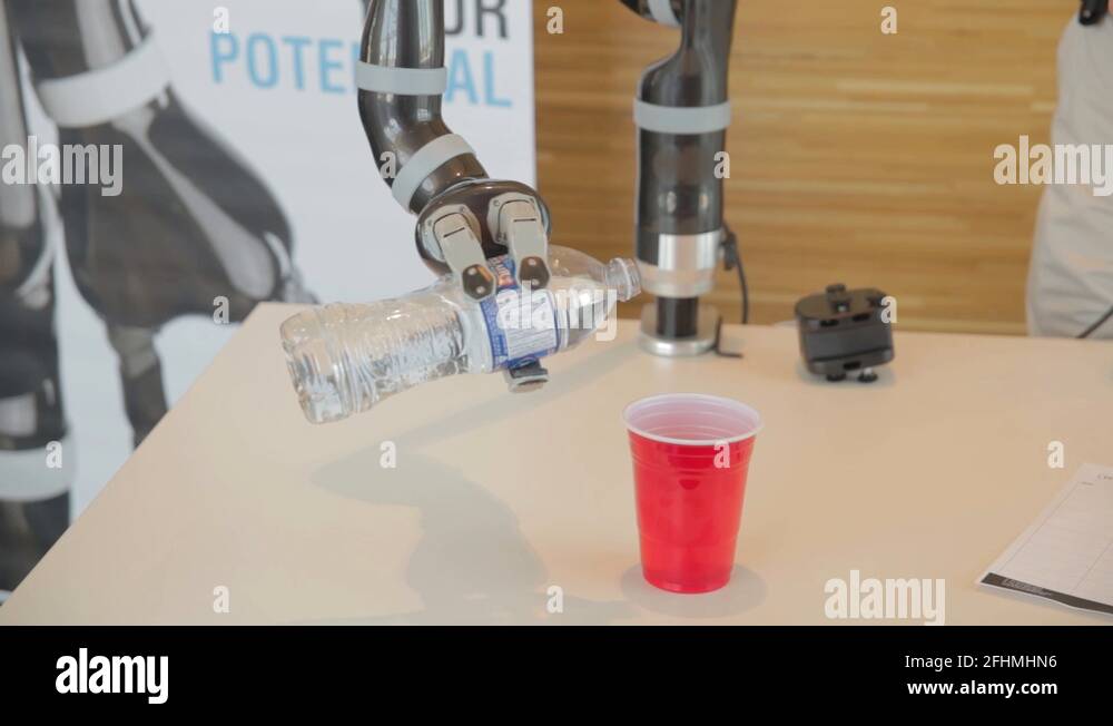 Robotic arm pouring water into a cup Stock Video Footage - Alamy