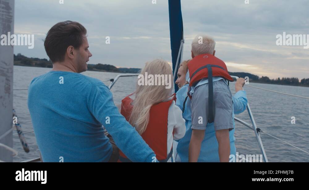 Caucasian family parents and two kids boy and girl enjoying their boat ...