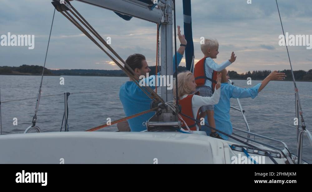 Caucasian family parents and two kids boy and girl enjoying their boat ...