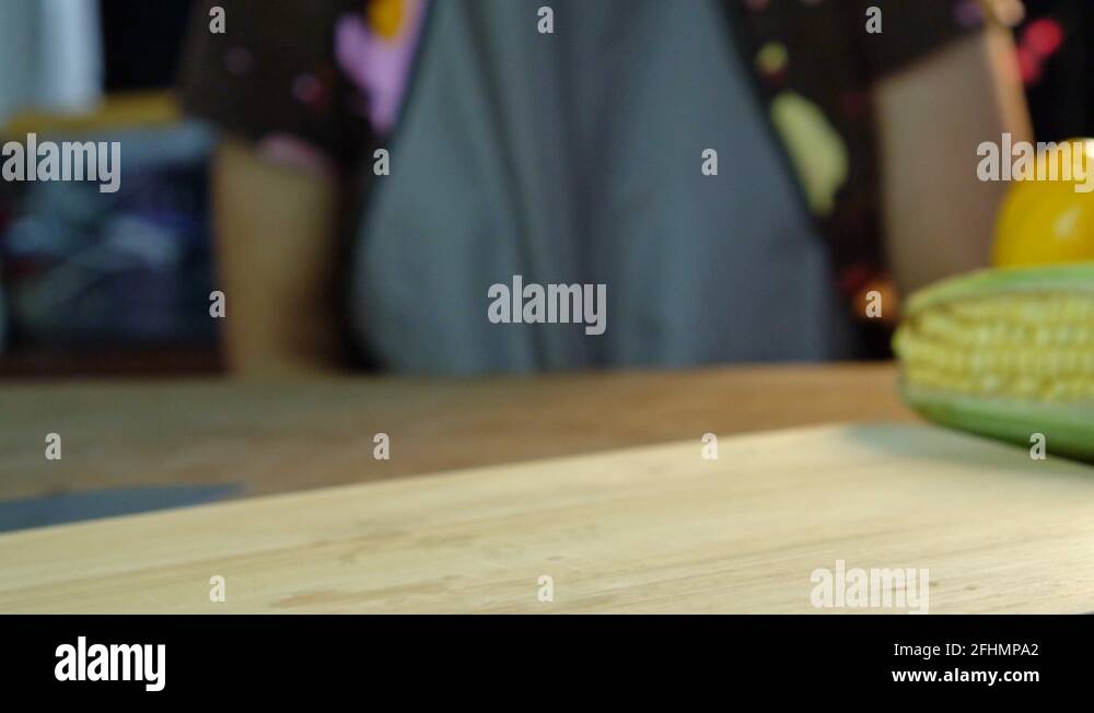 Asian female showing clean bright bell pepper on her palm in kitchen ...
