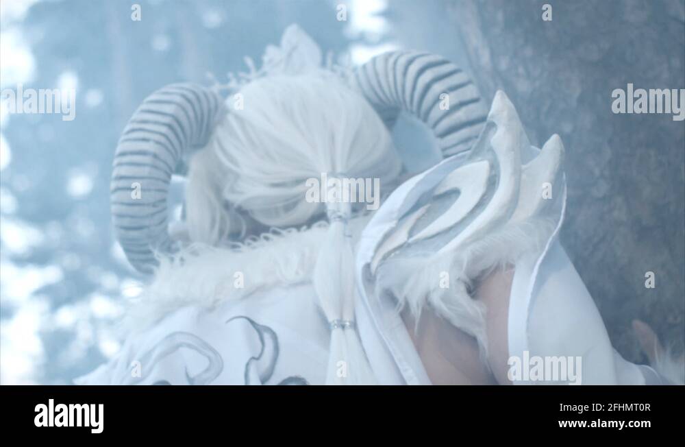 Back view of magical forest-dwelling satyr woman, walks and touches ...