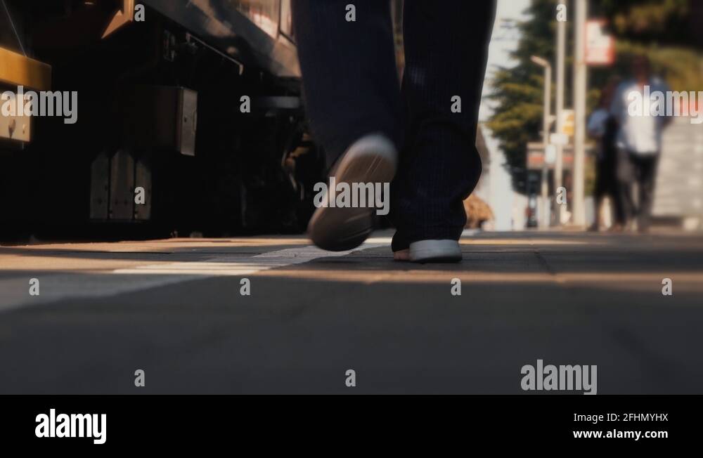 Departure of the train from the platform, hurrying passengers go on the ...